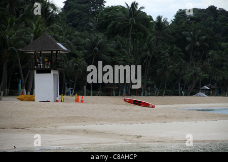 A lifeguard gazes out across the south China sea on Palawan Beach ...