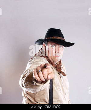 Old cowboy, point and angry face at studio, costume and pipe for ...