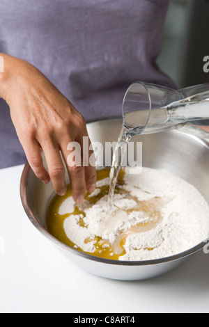Adding water to the flour Stock Photo - Alamy