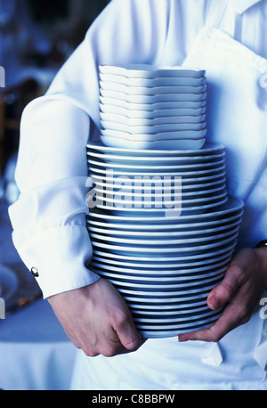 Man carrying plates Stock Photo - Alamy