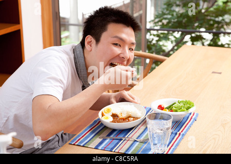 Man eating curry Stock Photo - Alamy