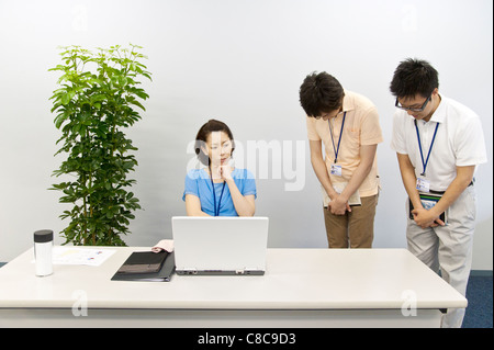 Staffs bowing to boss at office Stock Photo - Alamy