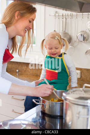 Mother and daughter cooking dinner in a kitchen Stock Photo - Alamy