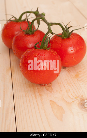 Fresh tomatoes on rustic wooden background. Tomatoes on wooden table ...
