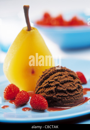 Blue ice cream with chocolate in coconut bowl on wooden background ...
