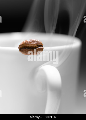 a cup of hot steaming coffee on a sunny morning on the kitchen table ...