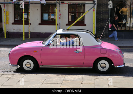 A pink Nissan Figaro car Stock Photo - Alamy