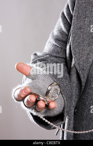 An old west cowboy looking at his pocket watch Stock Photo - Alamy
