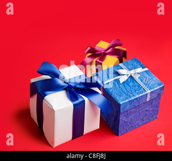 Three present boxes with red bow, christmas balls and snow fir-tree on ...
