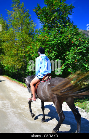 Young Chinese woman riding horse Stock Photo - Alamy