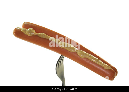 Wieners with mustard on a fork on a white background Stock Photo - Alamy