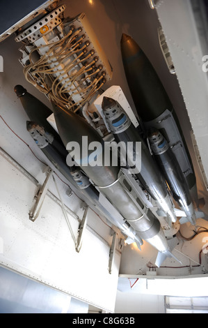 A 500-pound Joint Direct Attack Munition (JDAM) is lined up on a B-52 ...