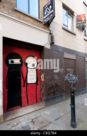 Street art by Stik - woman in traditional dress and man - black and ...