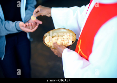 Catholic priest giving holy communion to a nun Stock Photo - Alamy