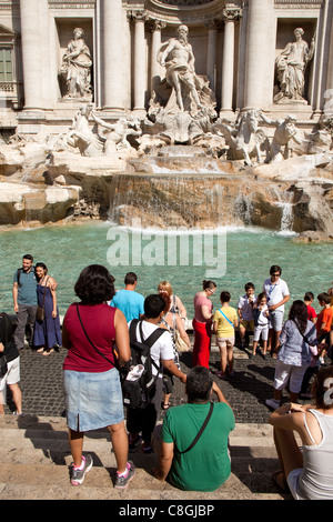 Men and women tourists at the Trevi Fountain, Rome, Italy. City trip ...