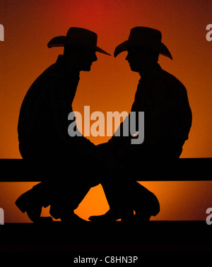 Two cowboys sitting on the fence at a rodeo Stock Photo - Alamy