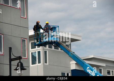 Men working in cherry pickers Stock Photo - Alamy