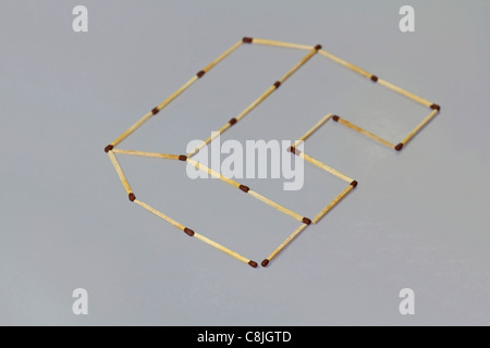 Matches arranged in shape of house Stock Photo - Alamy