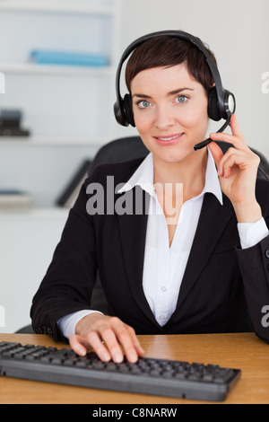 Portrait of a serious secretary calling with a headset Stock Photo - Alamy