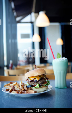 Cheeseburger, french fries and milkshake in diner Stock Photo - Alamy
