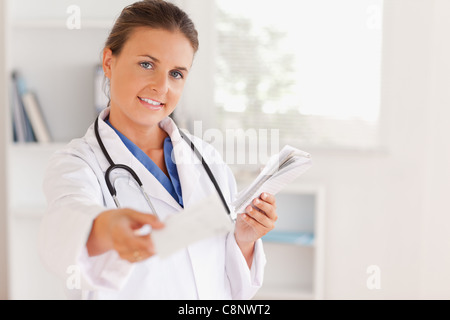 Charming brunette doctor handing out a prescription Stock Photo - Alamy