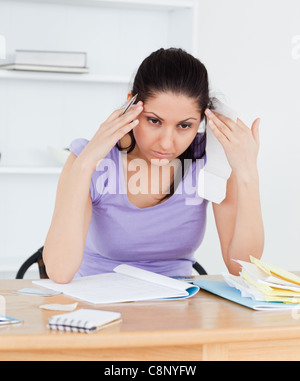 A young accounting woman is having a headache Stock Photo - Alamy