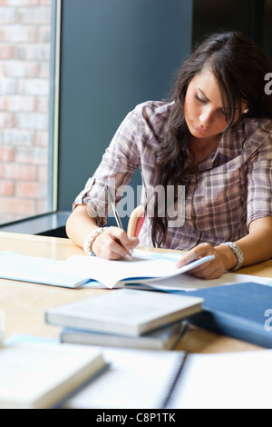 Beautiful student writing an essay Stock Photo - Alamy