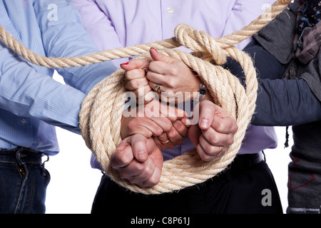 Male hands bound by rope, female hands pulling rope, cropped view Stock ...
