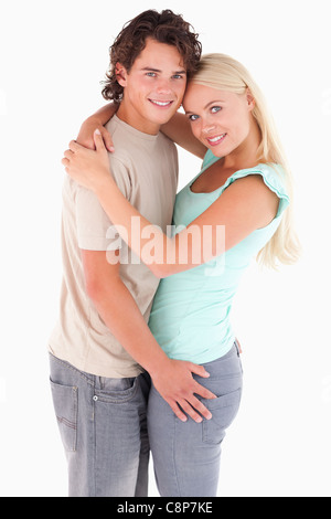 Pretty lovers hugging and looking camera isolated Stock Photo - Alamy