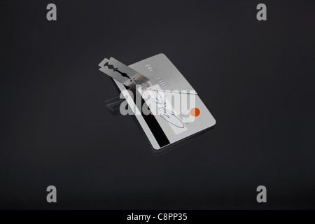 Slicing my credit card with a razor blade. High key and copy-space ...