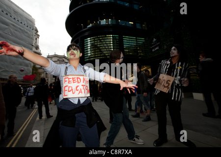 London, UK, 31/10/2011. Activists dressed as zombies staggering around ...