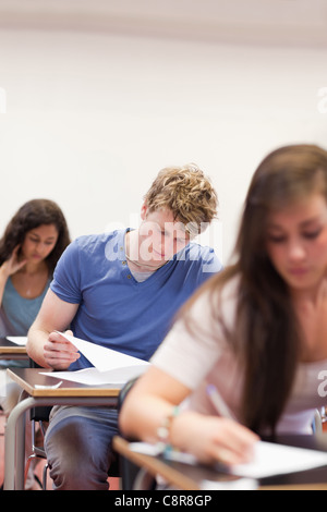 Portrait of young students doing an assignment Stock Photo - Alamy