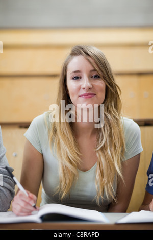 Female student holding a pen Stock Photo - Alamy