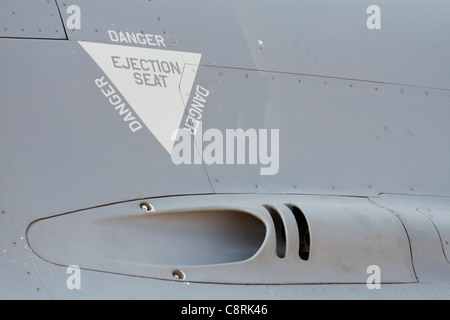 Ejection seat warning sign on the side of a plane Stock Photo - Alamy