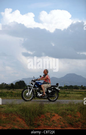 European man riding a Bullet Enfield in Andhra Pradesh South India ...