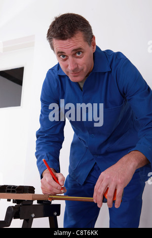 carpenter using pencil while drawing a board Stock Photo - Alamy