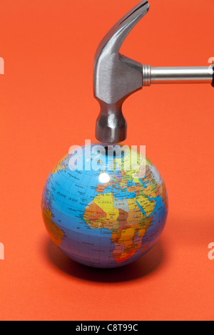 Globe And Hammer With Orange Background Stock Photo - Alamy