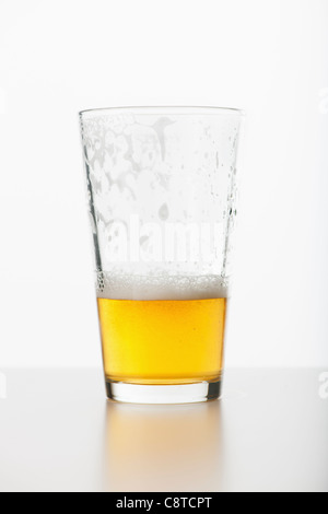 Half Glass of Lager Stock Photo - Alamy