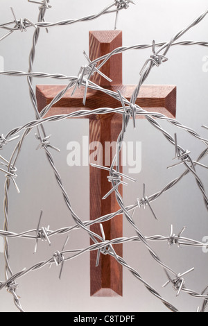 Barbed metal wire cross close-up on gray background. Border protection ...