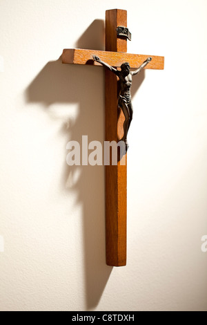 Vertical shot of a wooden crucifixion of Christ cross on a yellow ...