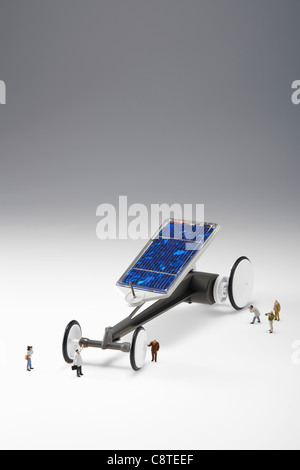 Solar powered car with a view of its solar panel and wheels on a white ...