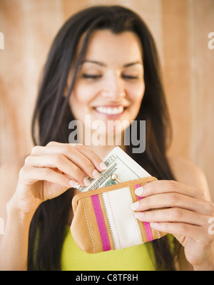 Woman taking money from purse Stock Photo - Alamy