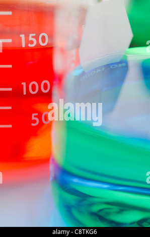 Two laboratory beakers with green liquid stand next to American ...