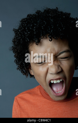 Upset child screaming. Mixed race Kid yelling roaring to camera, close ...