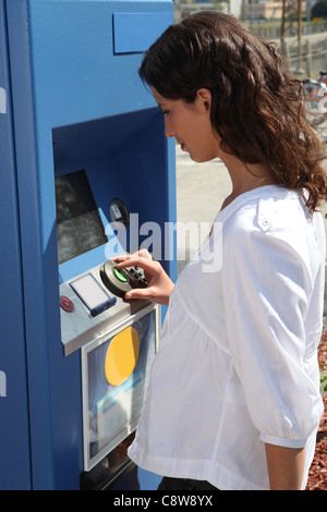 A blue bus ticket validation machine at the entrance to a U-Bahn metro ...