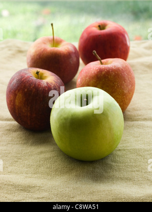 Close up of four green apples over light green background Stock Photo ...