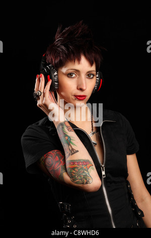 Young Woman Listening to Music on Smartphone While Applying Clay Face ...