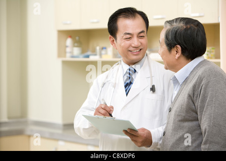 Doctor Shows a Senior Man a Chart Stock Photo - Alamy