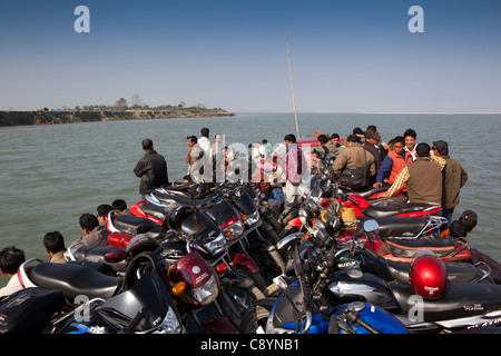 India, Assam, Jorhat, heavily overladen car and passenger ferry boat ...