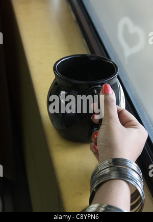 Woman wearing bangles and drinking coffee Stock Photo - Alamy